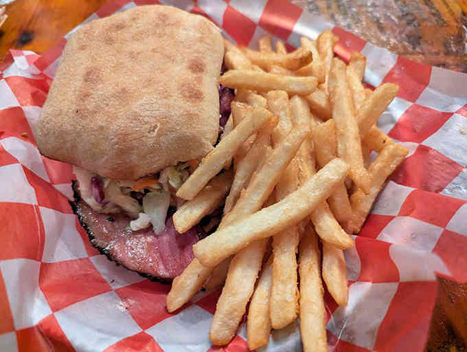 Pastrami piled high on fresh bread with crispy fries; this sandwich means serious business in the flavor department.
