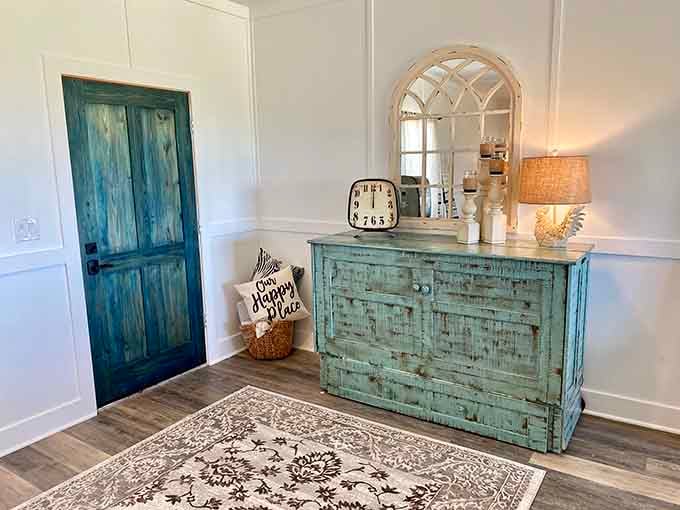 Turquoise distressed furniture and vintage mirrors prove that farmhouse chic pairs surprisingly well with exotic animal neighbors just outside.