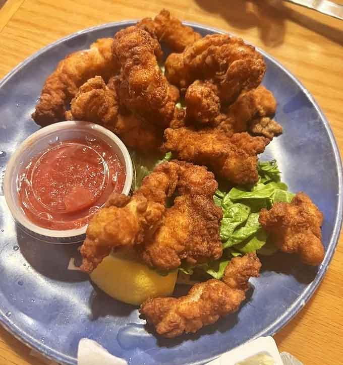 Golden fried clam strips that crunch like autumn leaves but taste infinitely better than yard work.