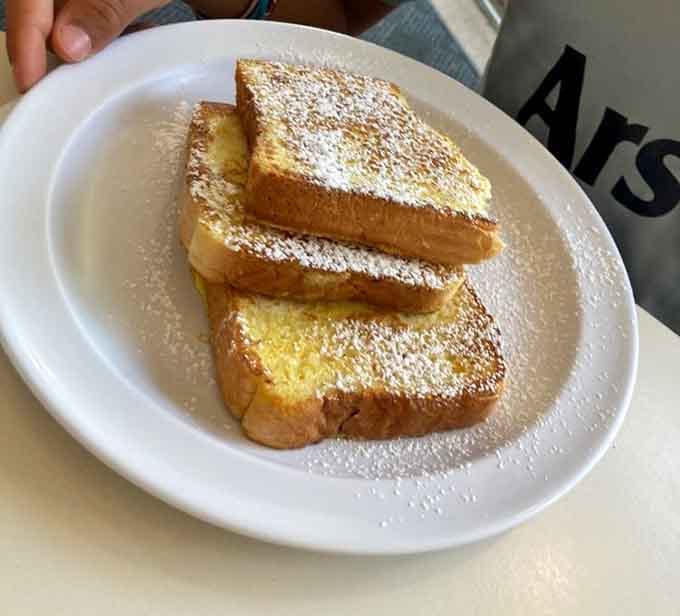 French toast stacked high and dusted with sweetness, because subtlety is overrated at breakfast time.