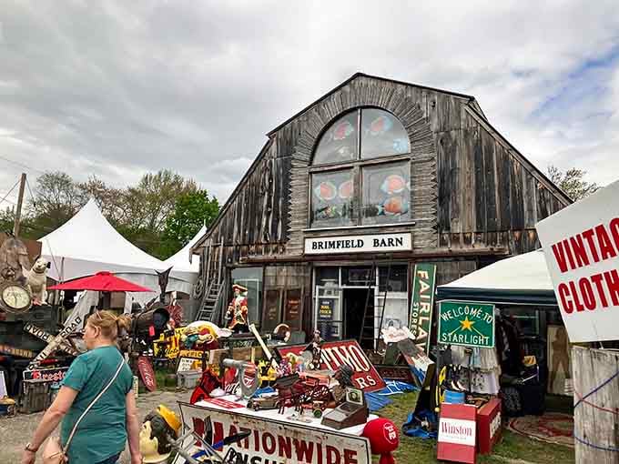 The Brimfield Barn stands proud, a weathered landmark that's witnessed decades of treasure hunters passing through.