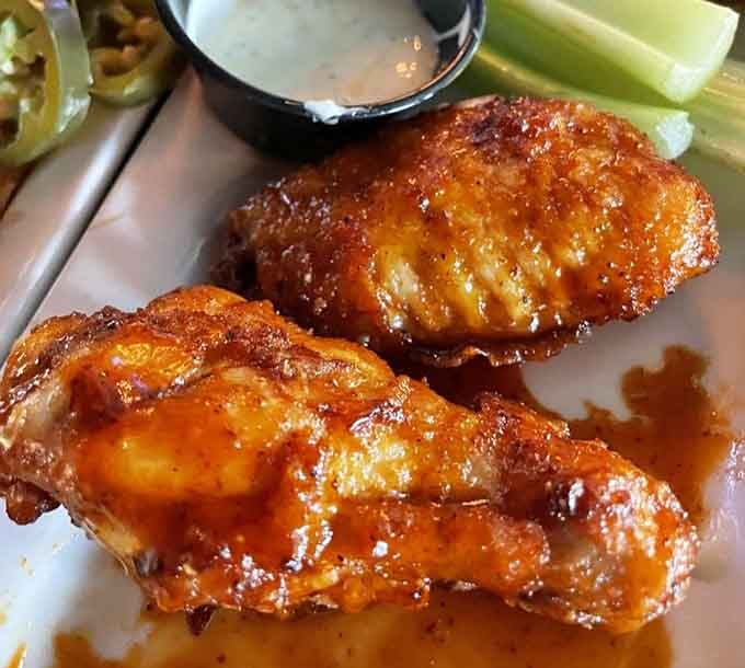 Wings glazed to perfection with that sticky-sweet shine that makes napkins absolutely mandatory, not optional at this table.