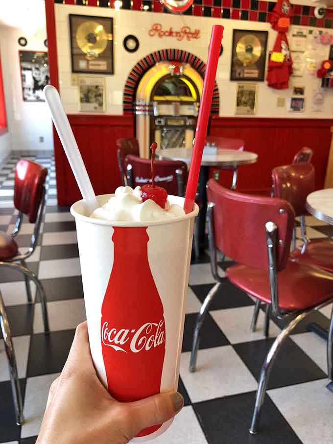 Holding happiness never looked so good, with that jukebox providing the perfect retro soundtrack behind you.