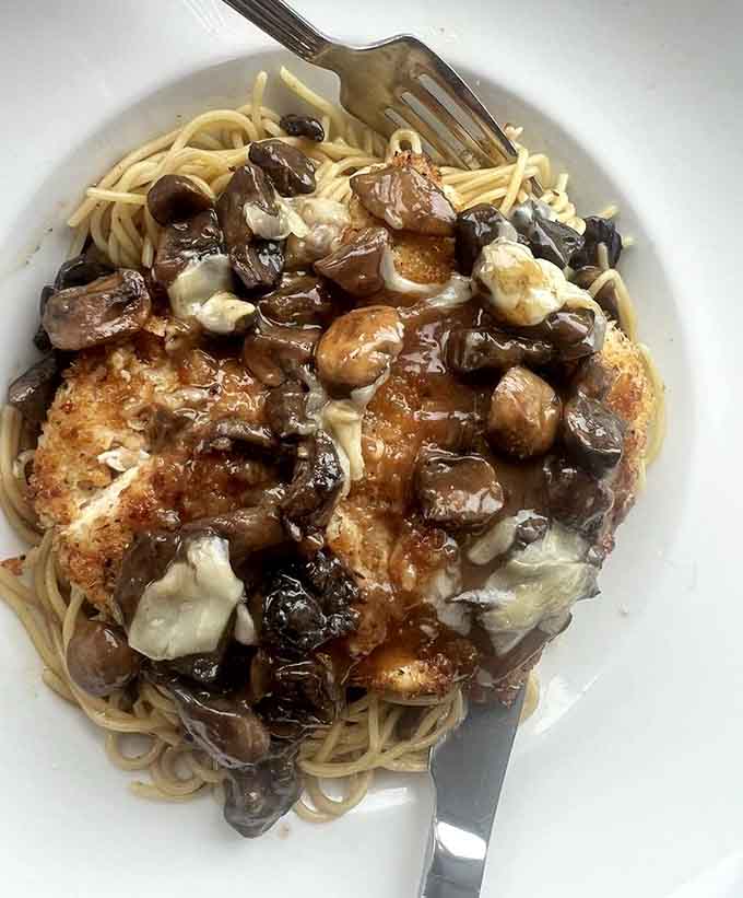 When mushrooms cascade over tender chicken like a savory waterfall, you've found the marsala that ruins all other marsalas forever.