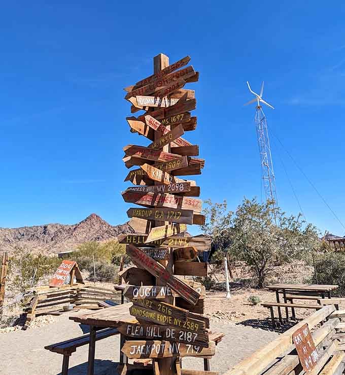 Every weathered sign tells a visitor's story, creating a quirky timeline of everyone who discovered this desert treasure.
