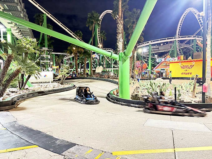 Go-karts zip around the track at night, their lights streaking past like colorful comets in the desert darkness.