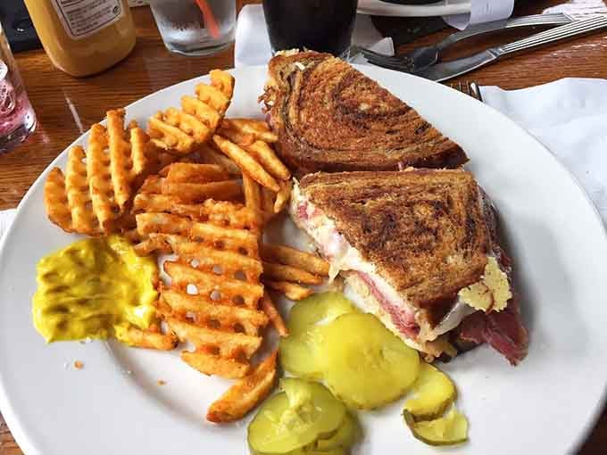 The Reuben arrives with waffle fries, because sometimes sandwiches need equally impressive sidekicks for the journey.
