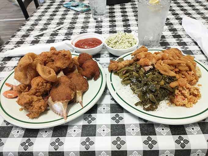 Two plates of pure Southern bliss featuring fried seafood and collard greens that would make any grandmother proud indeed.