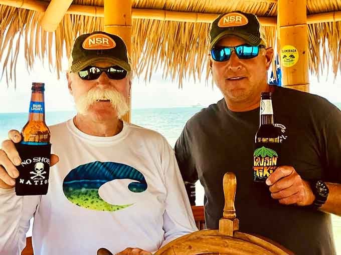 Two generations, two beers, and one floating tiki bar proving that good times transcend age and questionable fashion choices.