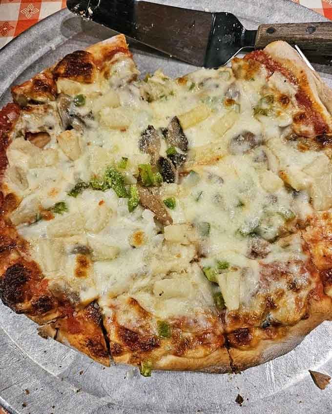 Green peppers peek through bubbling cheese like emeralds in a dairy treasure chest of deliciousness.