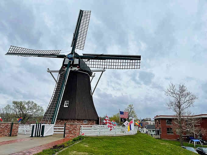 International flags flutter in the breeze, celebrating the immigrant spirit that built this remarkable structure.