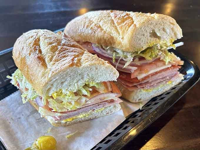 That Italian combo showcases perfectly stacked meats and fresh vegetables on bread that actually holds up to the job.