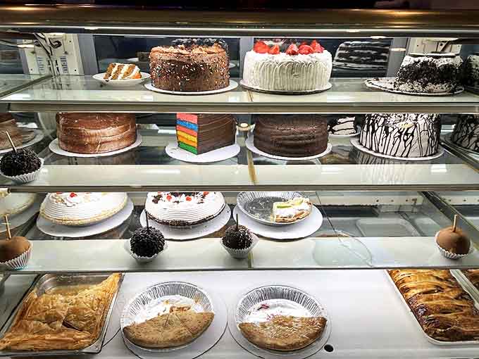 The dessert case displays layer cakes, pies, and sweet temptations that make your dinner resolution immediately regret its life choices.