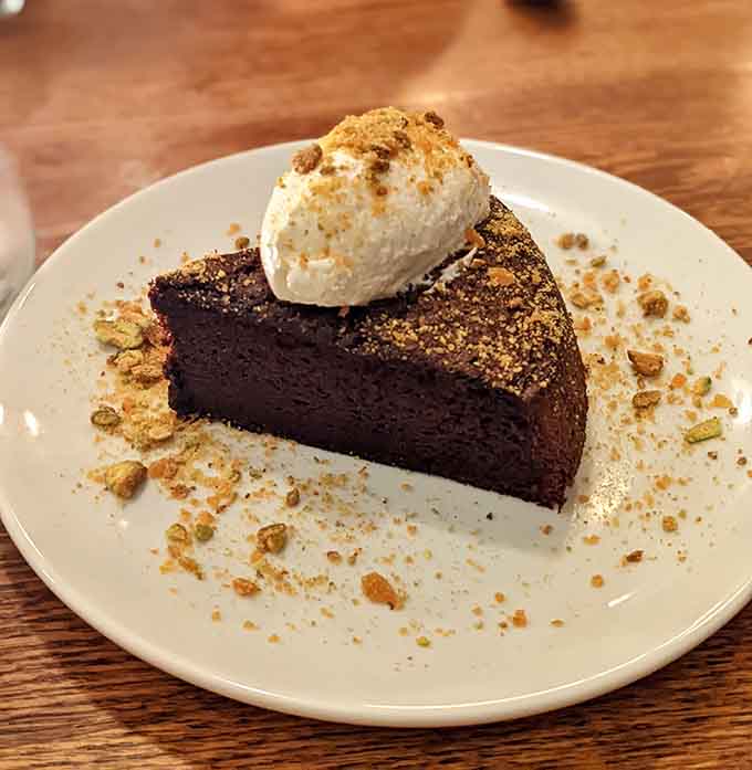 Chocolate olive oil torta topped with whipped cream, because sometimes dessert needs to be this decadent and unapologetic.