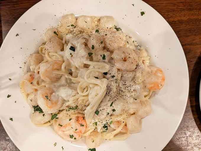 Creamy Alfredo sauce embraces shrimp and pasta in a comforting, delicious culinary group hug here.