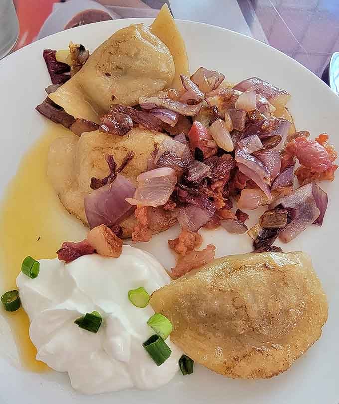Saut&eacute;ed pierogies glistening with butter and caramelized onions represent comfort food at its absolute finest and most satisfying.