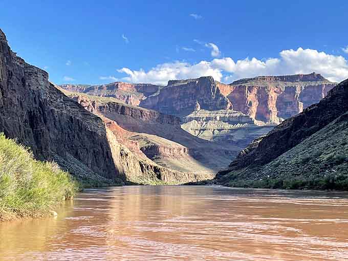 The mighty Colorado River snakes through towering canyon walls, still carving its masterpiece after millions of patient years.