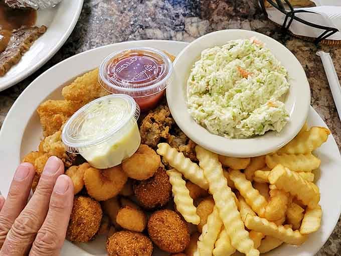 This seafood platter loaded with shrimp, scallops, and hush puppies could convert any landlubber instantly.