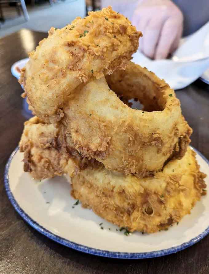 These onion rings stand tall and proud, achieving architectural heights that would make any engineer jealous and hungry.