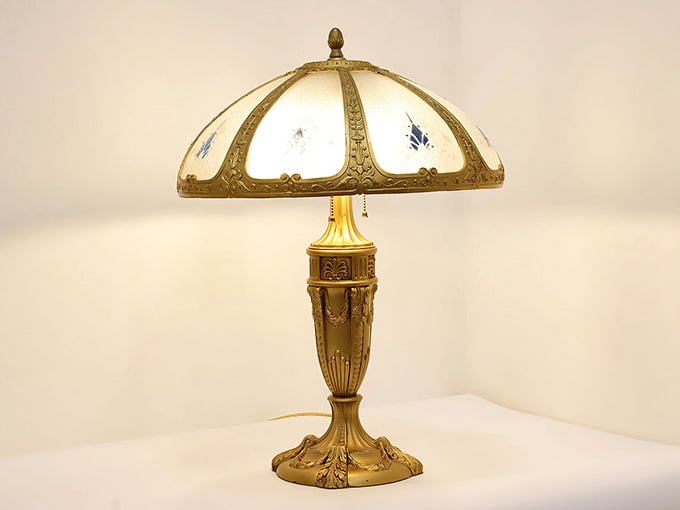 This ornate brass table lamp glows like a warm secret from another, more elegant century.