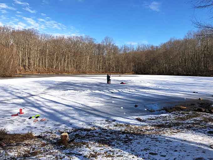 Winter transforms the frozen pond into Connecticut's most scenic ice rink, though skating isn't exactly encouraged here.