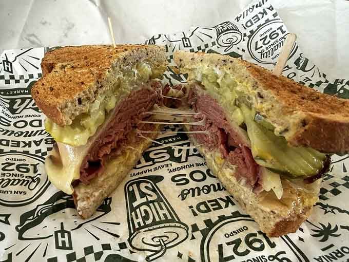 Hot pastrami on rye with melted cheese creates the kind of comfort that makes everything else seem manageable.