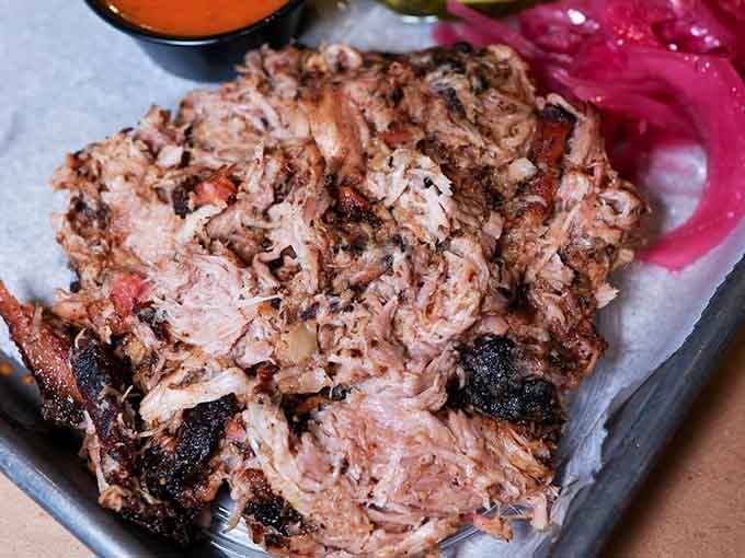 Pulled pork so tender it practically pulled itself, now waiting patiently for your fork.