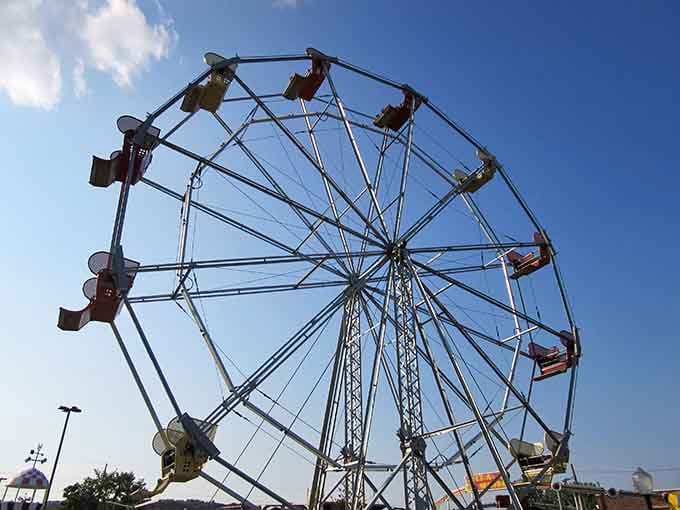 The Ferris wheel stands tall against blue skies, offering views that make even adults feel like kids again.