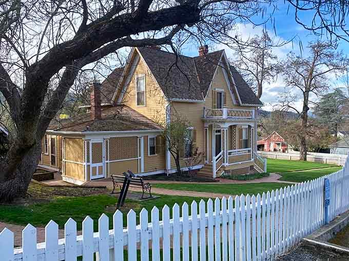 Yellow Victorian charm meets white picket fence perfection in a scene that would make any postcard jealous of its good looks.