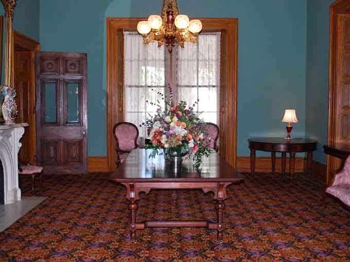 The parlor's turquoise walls and vintage pieces create an atmosphere that's equal parts museum and welcoming living space.
