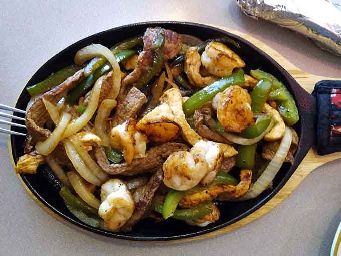 This fajita mixta combines chicken, steak, and shrimp in one glorious skillet of sizzling, smoky perfection.