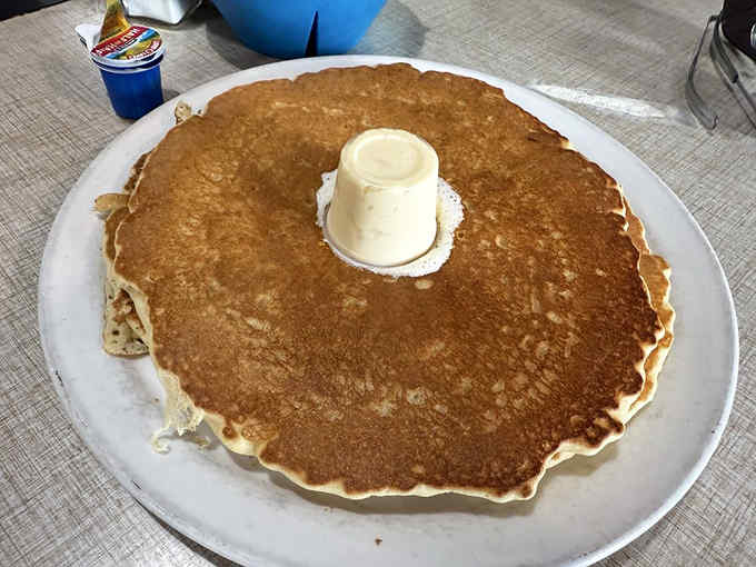 This pancake is so massive it could double as a personal flotation device in syrup emergencies.