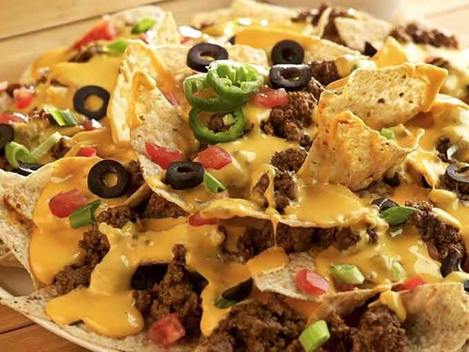 When nachos come loaded like this, you're not ordering an appetizer; you're making a serious life commitment.