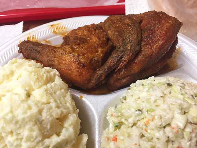 Half a chicken with white slaw and potato salad, the kind of plate that defines Southern hospitality.
