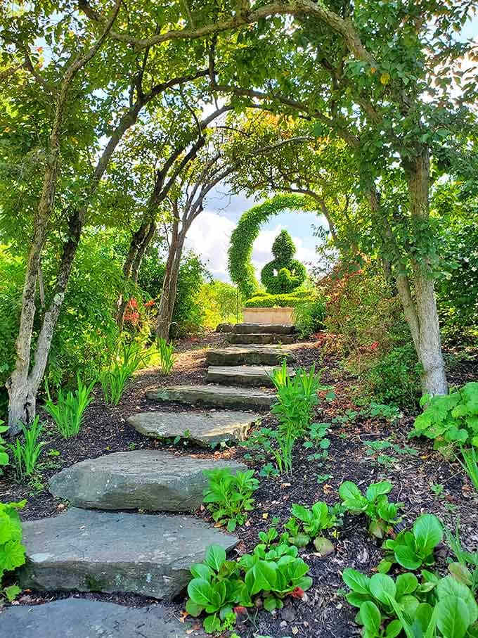 Stone steps leading through a leafy tunnel, because regular pathways are apparently too boring for this place.