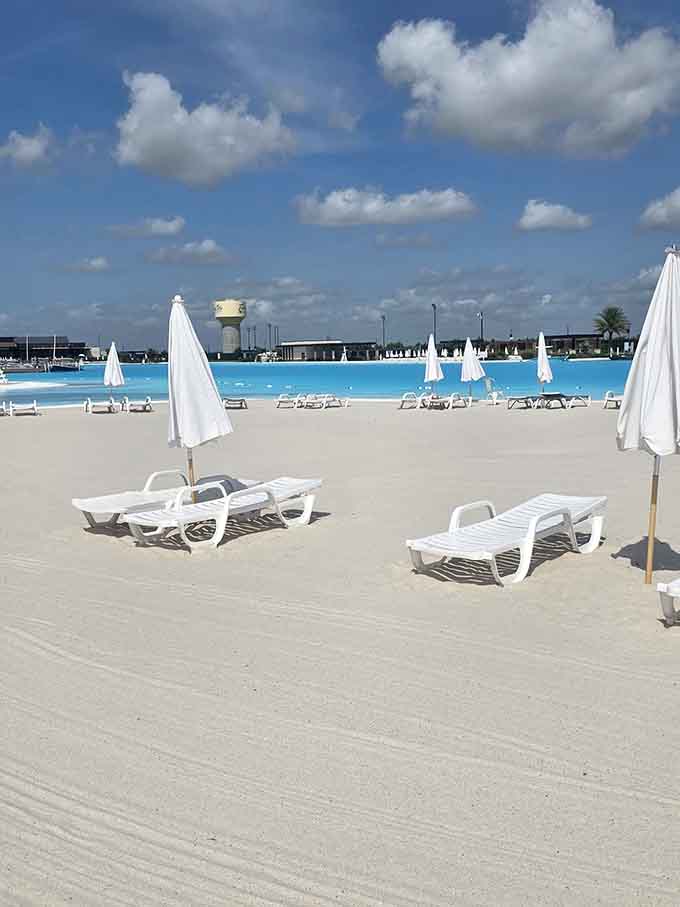 White lounge chairs on white sand facing impossibly blue water&mdash;it's like someone designed a postcard and forgot to mention it's real.