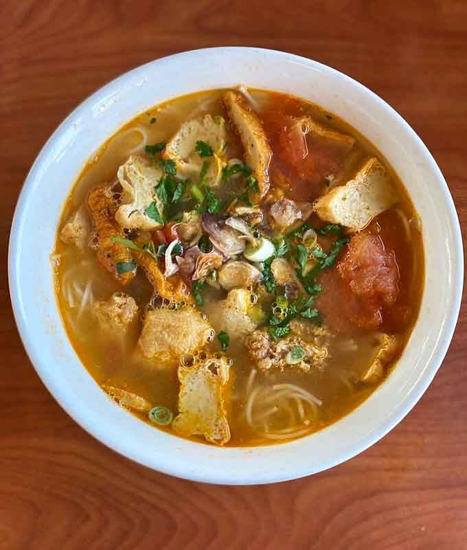 Bun rieu's tomato-based broth with crab and pork is comfort food that crosses all cultural boundaries beautifully.