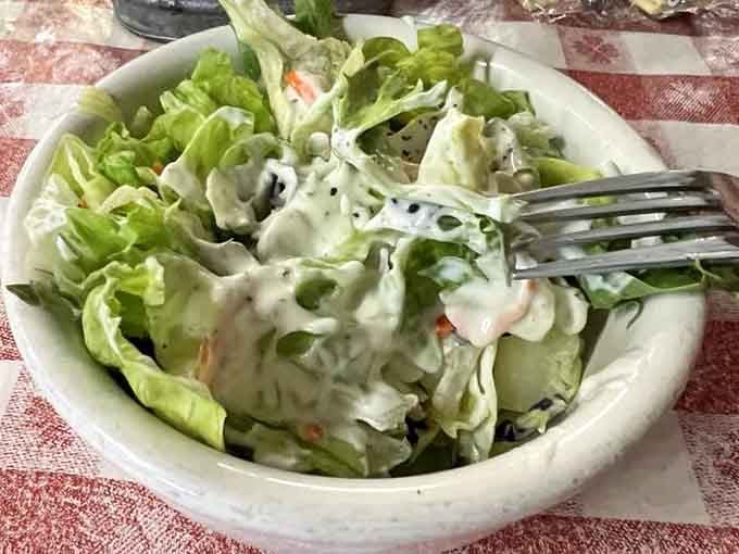 Fresh salad with creamy dressing provides the perfect counterpoint to all that glorious, unapologetic richness ahead.