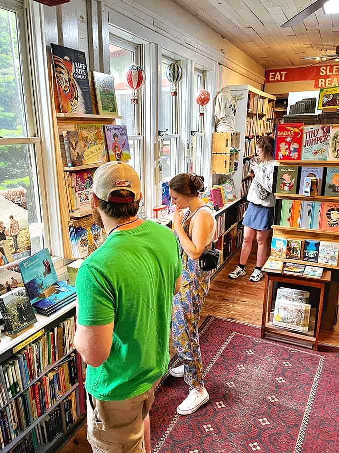 Real people browsing real books, proving that physical bookstores still beat algorithms at creating magical literary moments.