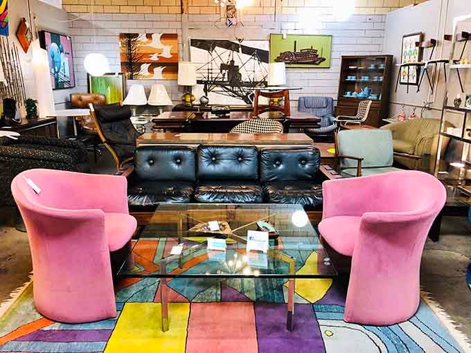 Pink velvet chairs facing a black leather sofa proves that opposites attract in the furniture world too.
