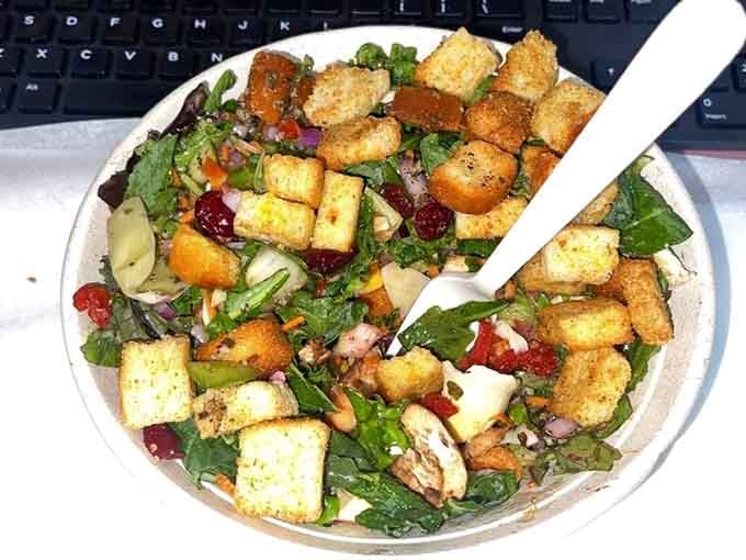 Golden croutons crown this vibrant bowl like tiny delicious jewels scattered across a garden of fresh, crisp possibilities.