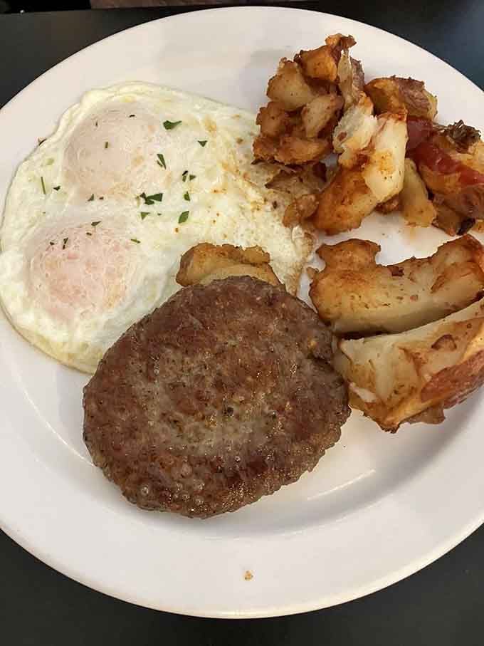 Two eggs, sausage, and those beautifully seasoned potatoes prove that simple done right beats fancy done wrong.