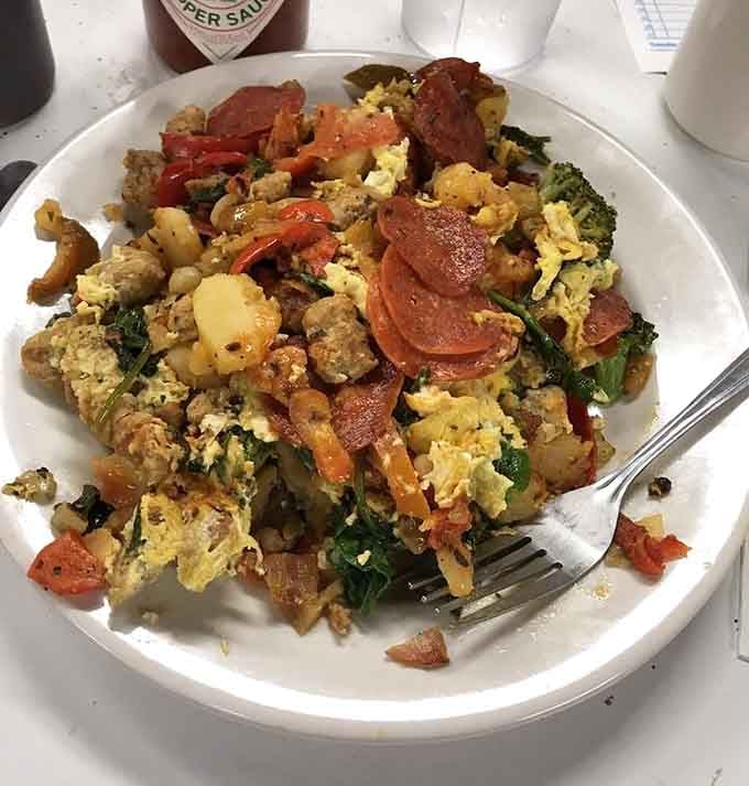 This colorful scramble loaded with peppers, potatoes, and Italian sausage looks like a party happened on your plate.