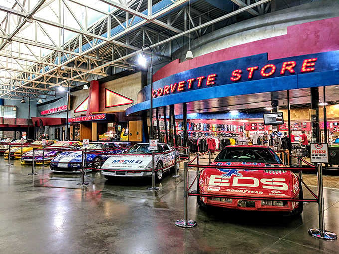 Racing legends wearing their battle scars proudly, reminding visitors that the Corvette Store sells dreams alongside die-cast models.