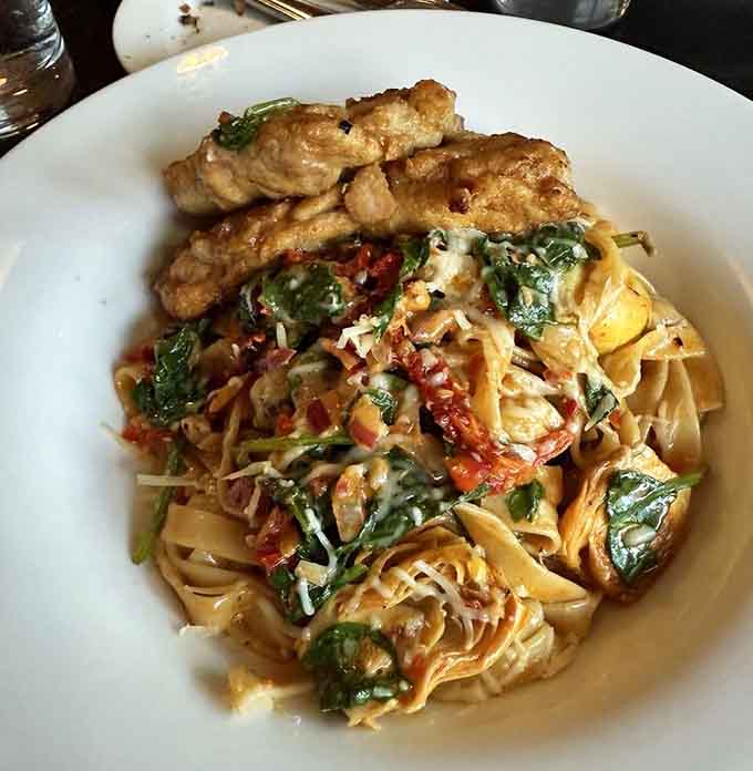 This chicken fettuccini with greens and sun-dried tomatoes is what happens when Italian comfort food gets a Mediterranean makeover.