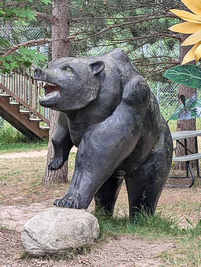 The gift shop's bear statue stands ready to greet visitors with a permanent smile and impressive photo opportunities.