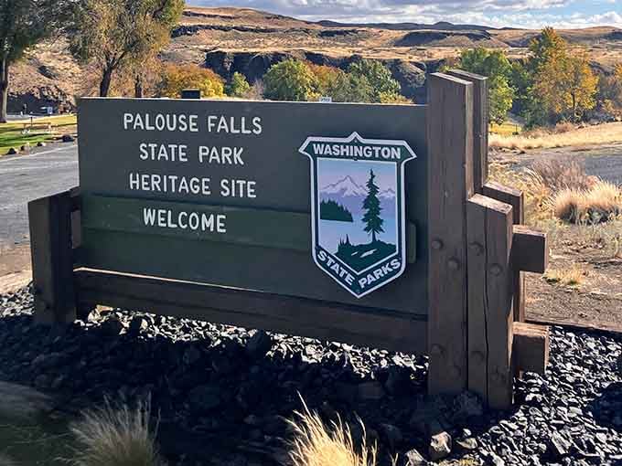 The welcome sign at Palouse Falls State Park, standing proud like a bouncer at nature's most exclusive venue.