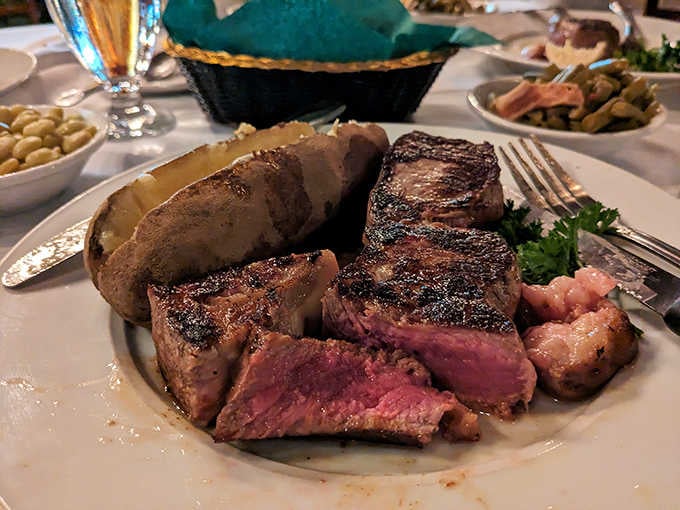 Beautifully seared steak with a baked potato so fluffy it could double as a pillow for tiny people.