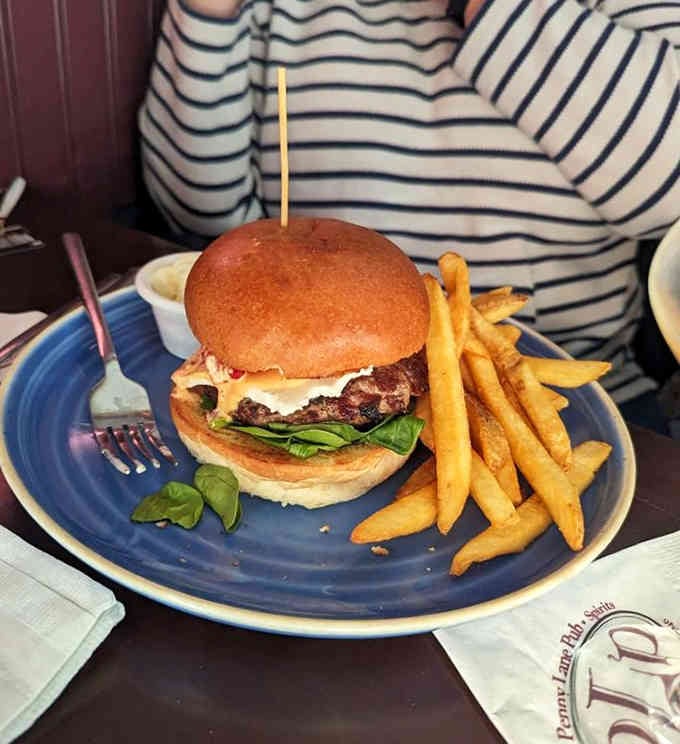 That lamb burger sits tall and proud, flanked by golden fries that could convert any skeptic instantly.