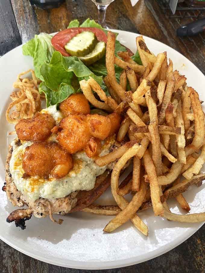 Crispy tater tots crown this burger like golden jewels, making healthy choices seem vastly overrated right now.